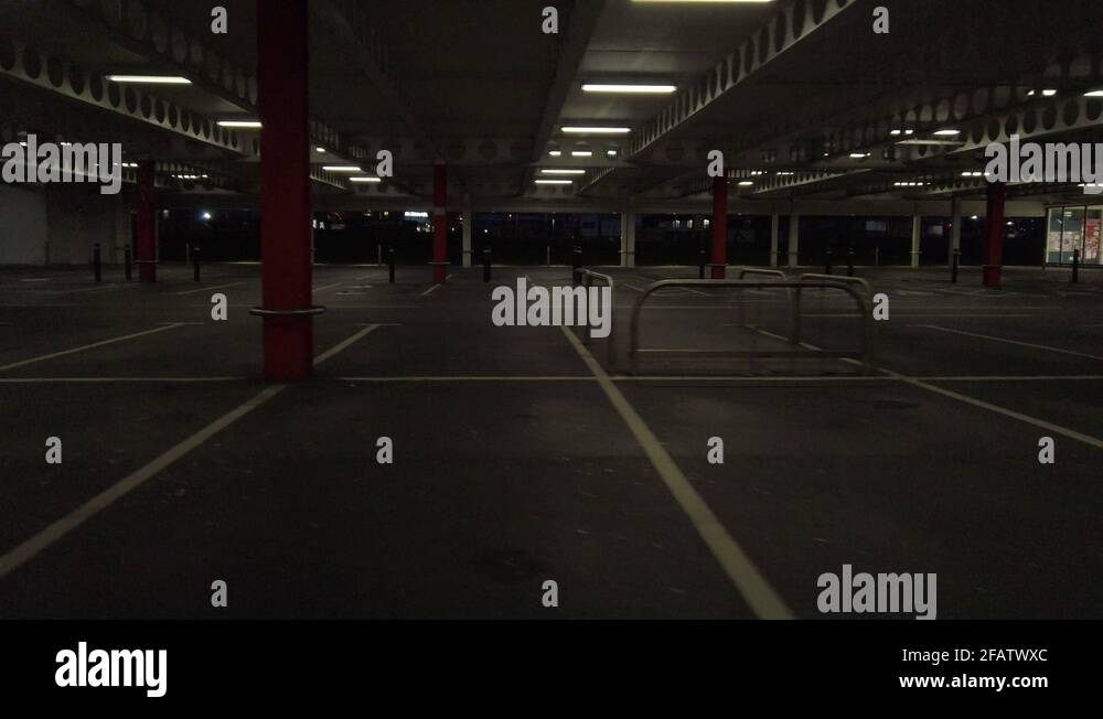 Driving view around empty creepy underground car parking lot basement ...