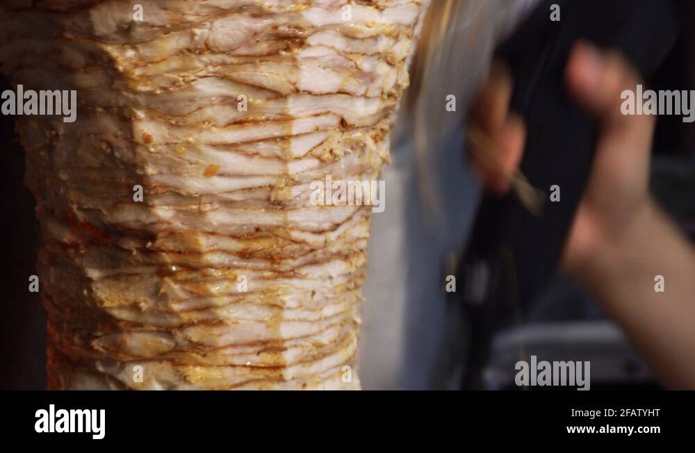 Cutting Meat on Vertical Rotisserie to Cook Gyros, Shawarma or Doner ...