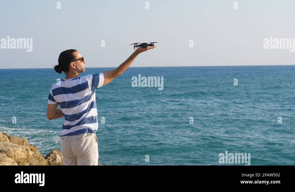 Man launch small aircraft from hand. Little drone liftoff and quickly ...