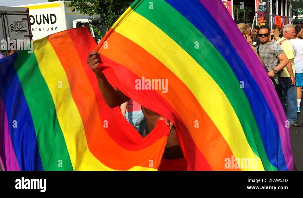 1080HD 60p, Black man waves 2 gay pride flags at Berlin, Germany gay ...