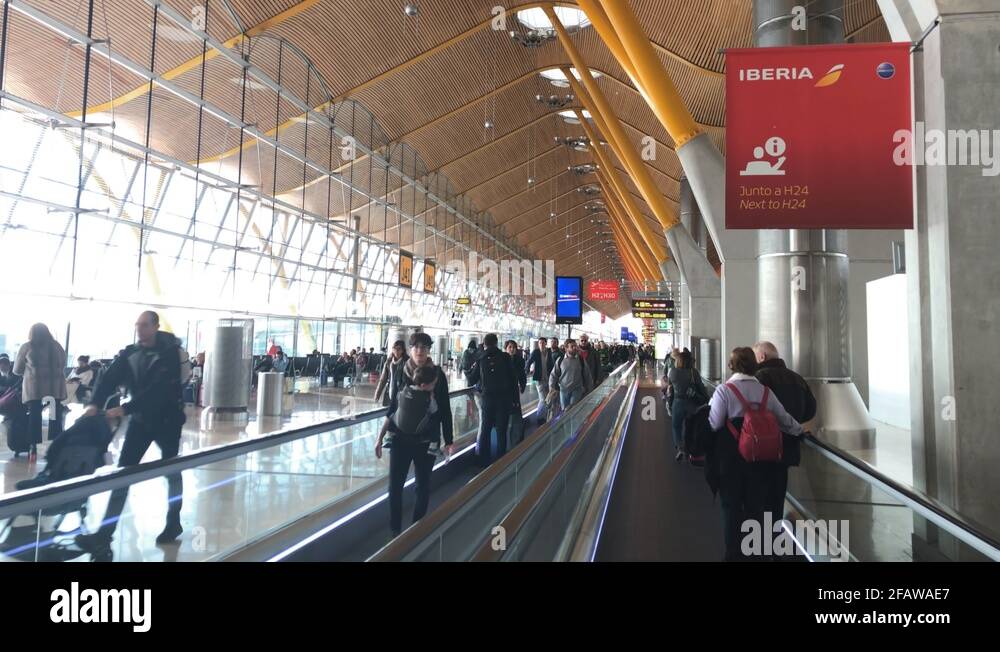 People riding an express walkway in both directions in modern terminal ...