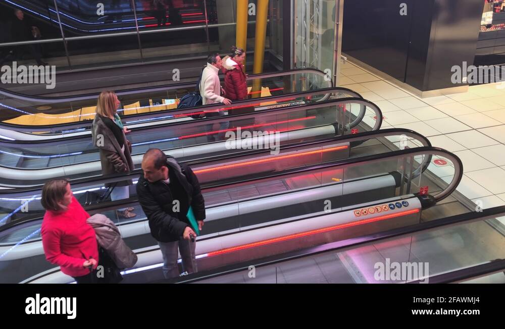 Two row escalator stair with people, parallel escalator staircase ...