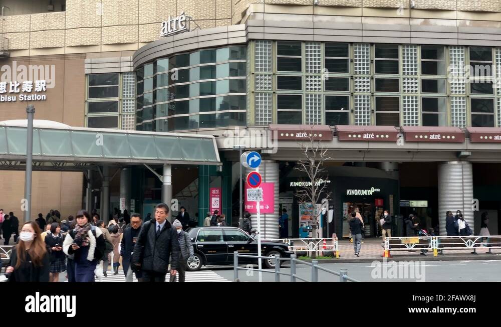 Panorama of West entrance-exit of Ebisu Station with people, taxi, bus ...