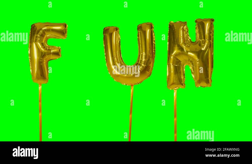 Word fun from helium golden balloon letters floating on green screen ...