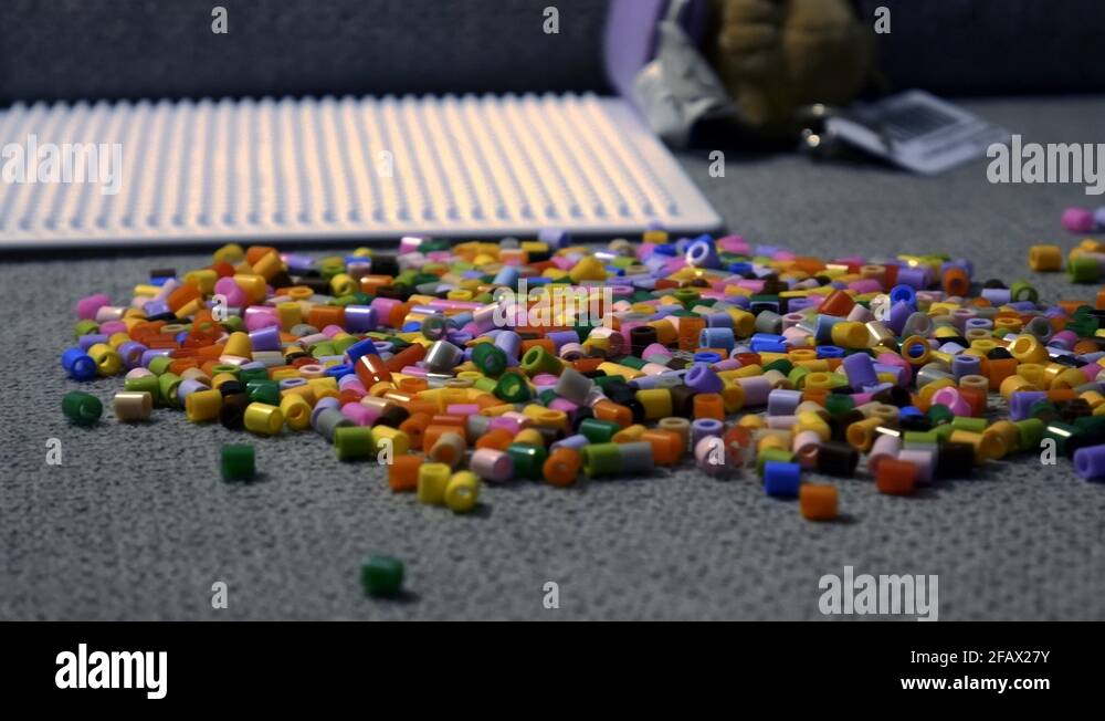 Child making art with perler beads,on the sofa Stock Video Footage - Alamy