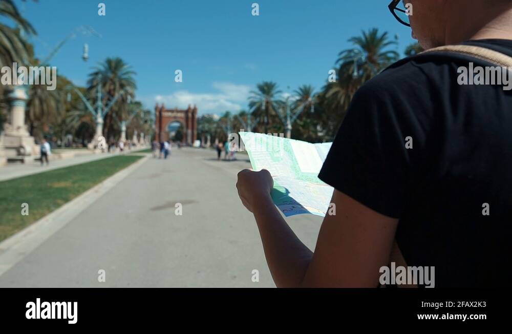 Confused tourist with a map in alley Stock Video Footage - Alamy