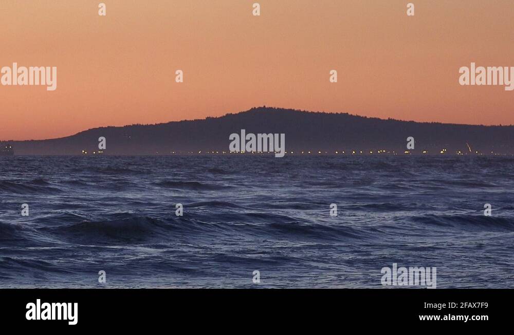 Pan from Long Beach skyline to offshore oil drilling rig Stock Video ...