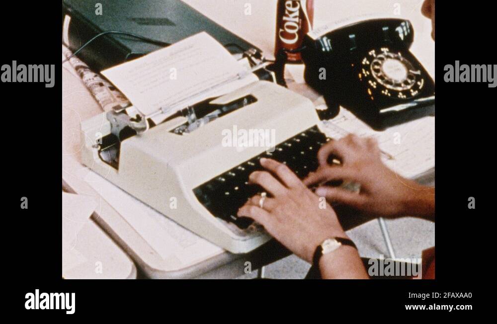 1960s: Man typing on typewriter. Woman at typewriter. Room full of ...