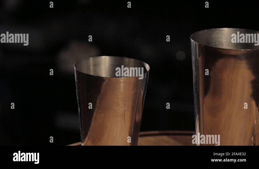 Cocktail shaker and beaker for preparation beverages on bar counter in ...