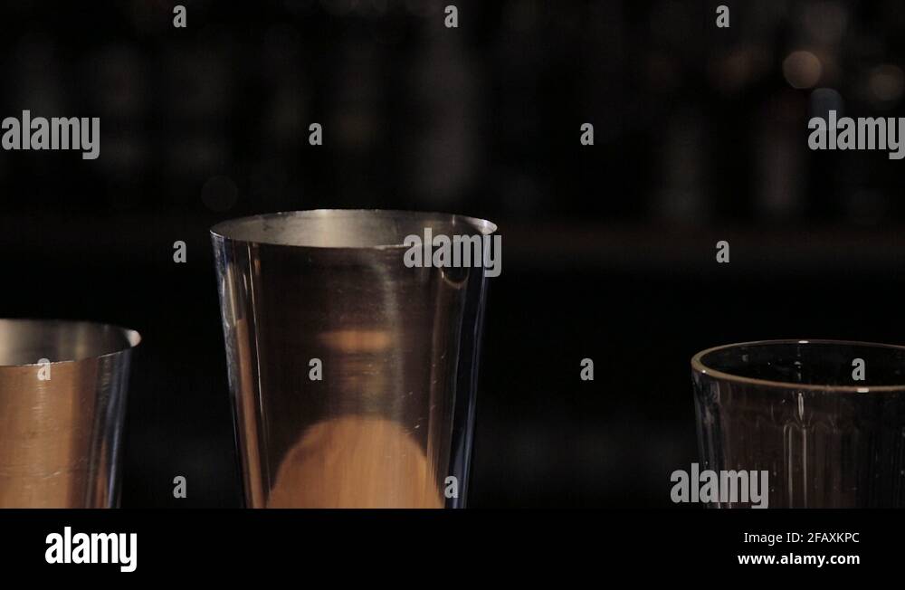 Cocktail shaker and beaker for preparation beverages on bar counter in ...