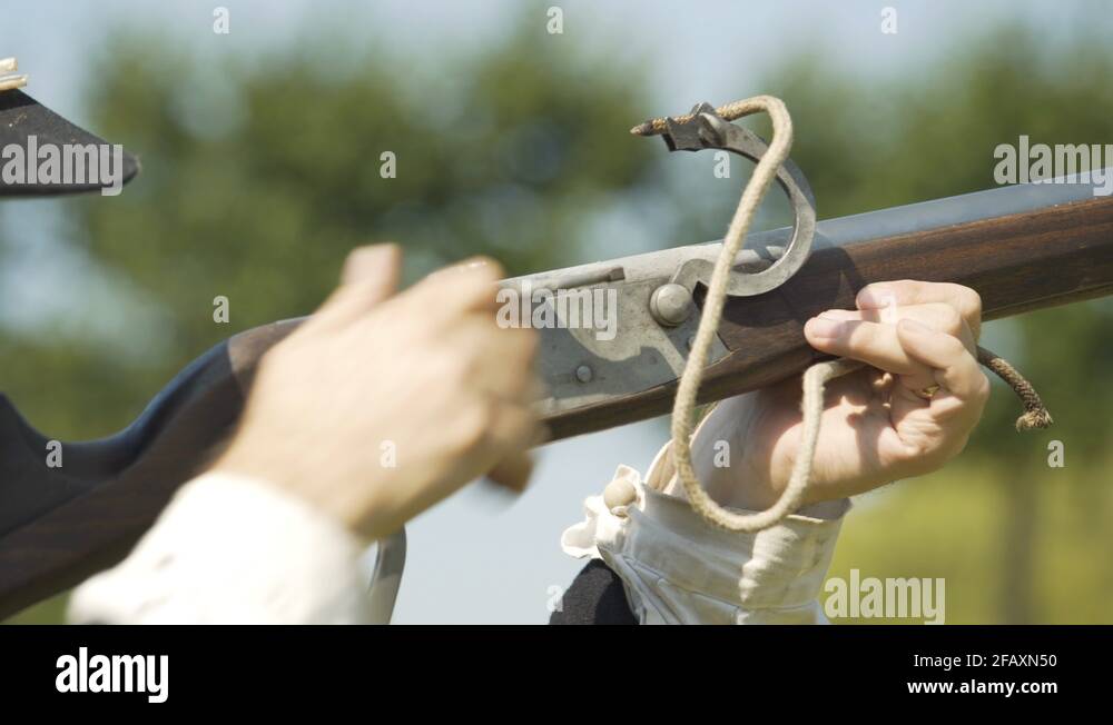 Loading, preparing and firing an old musket. Reenactment. Close up ...