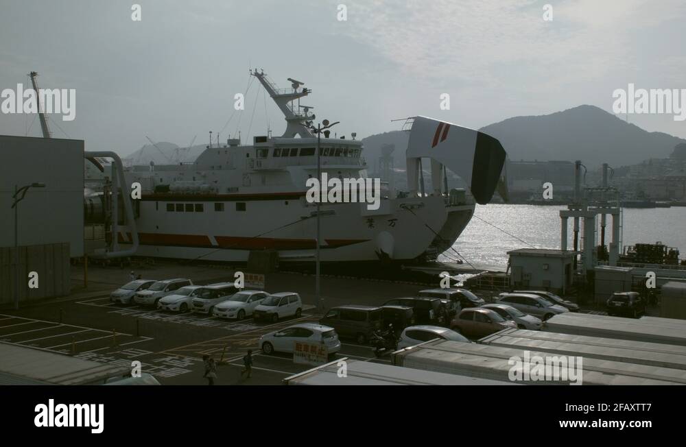 Large transporter ship with truck emerging from the cargo hold in ...