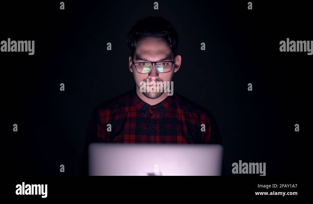 Frightened man look horror movie. Portrait of a man behind the monitor ...