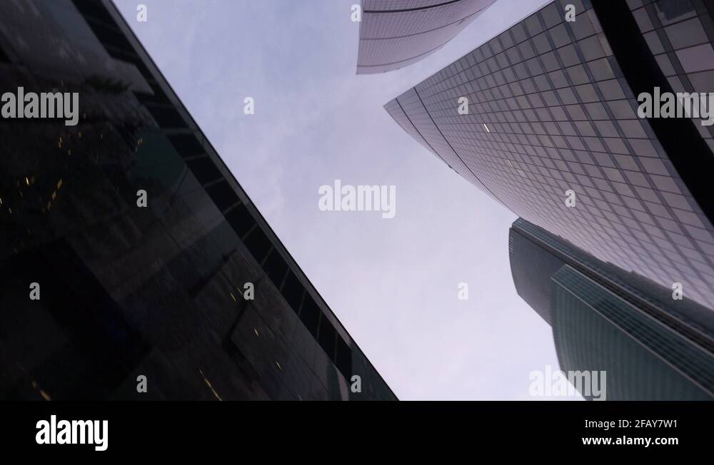 Panning view from below of the office tower buildings with vertical ...