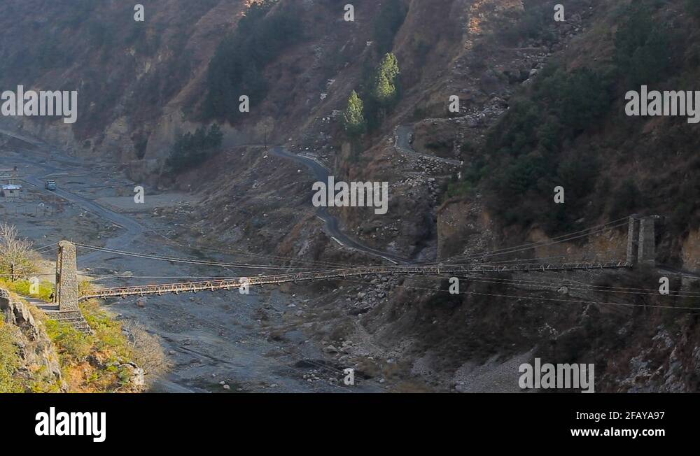 A dry river top view with a pedestrian bridge, People walking on the ...