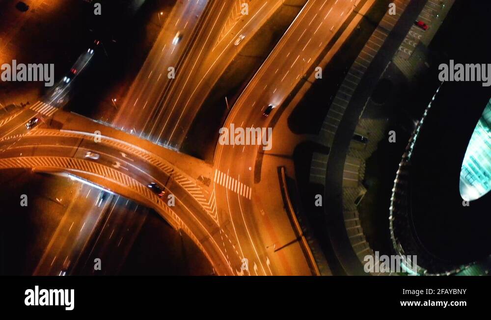 Top view, drone shot following a big roundabout and many roads, with ...