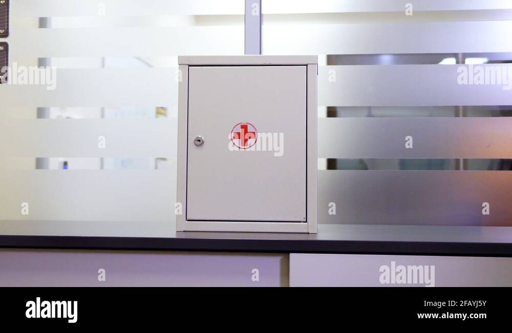 first aid kit box with red cross on shelf in modern office Stock Video ...