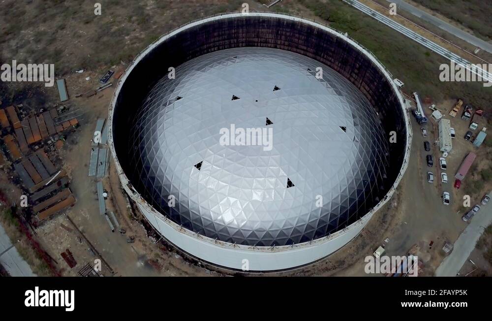 Crude oil storage tank from the air, high angle aerial pan of refinery ...