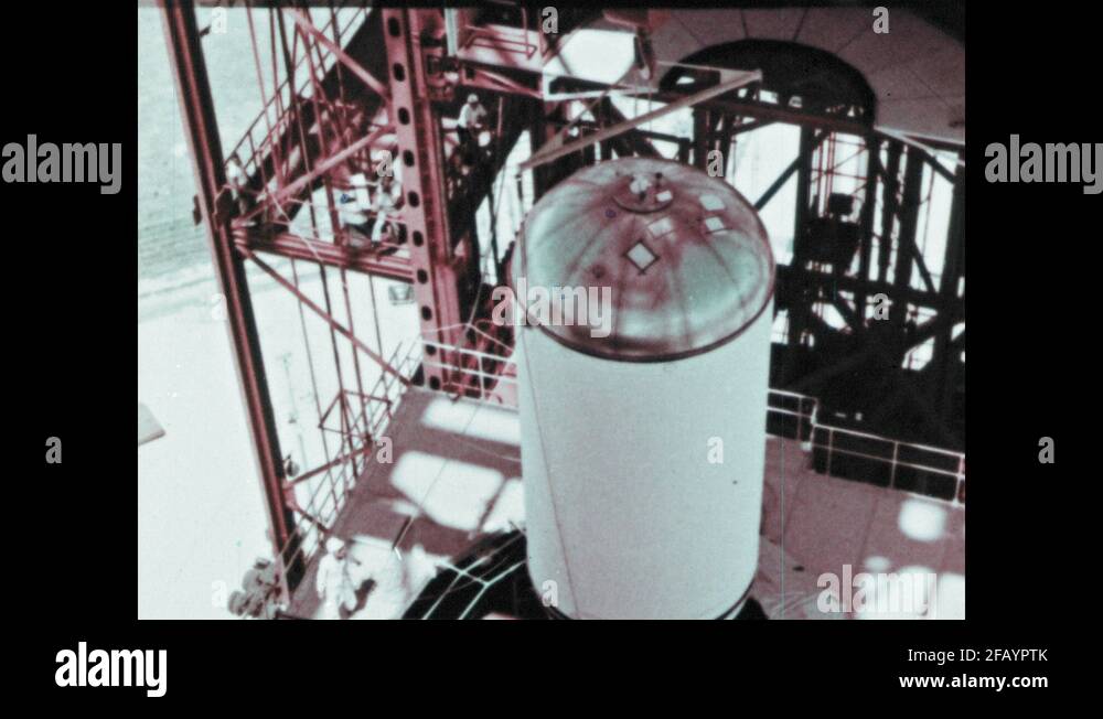 1960s: Stage of rocket is lowered into position on rocket being built ...