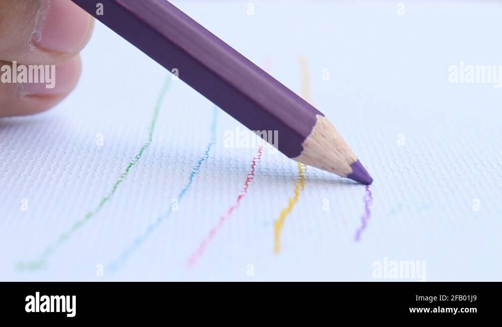 Artists hands drawing purple color pencil writes line on white paper ...