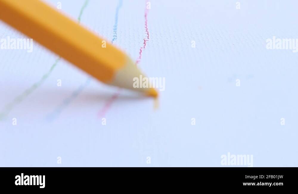 Artists hands drawing yellow color pencil writes line on white paper ...