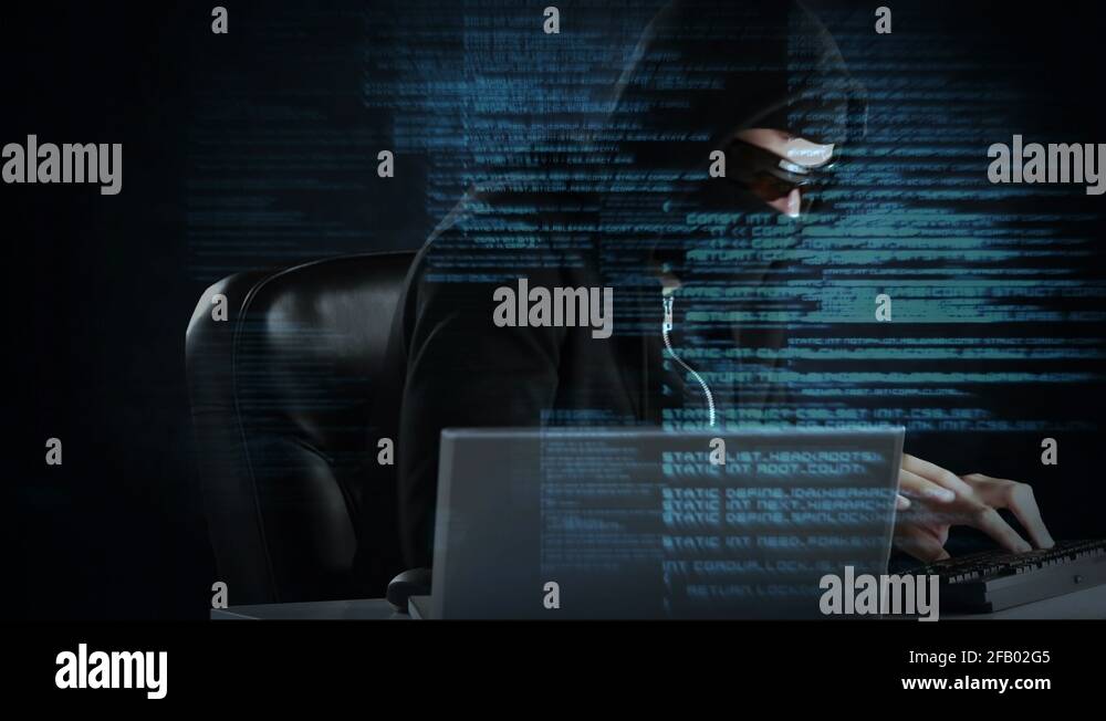 Hacker using computer in dark room with code Stock Video Footage - Alamy