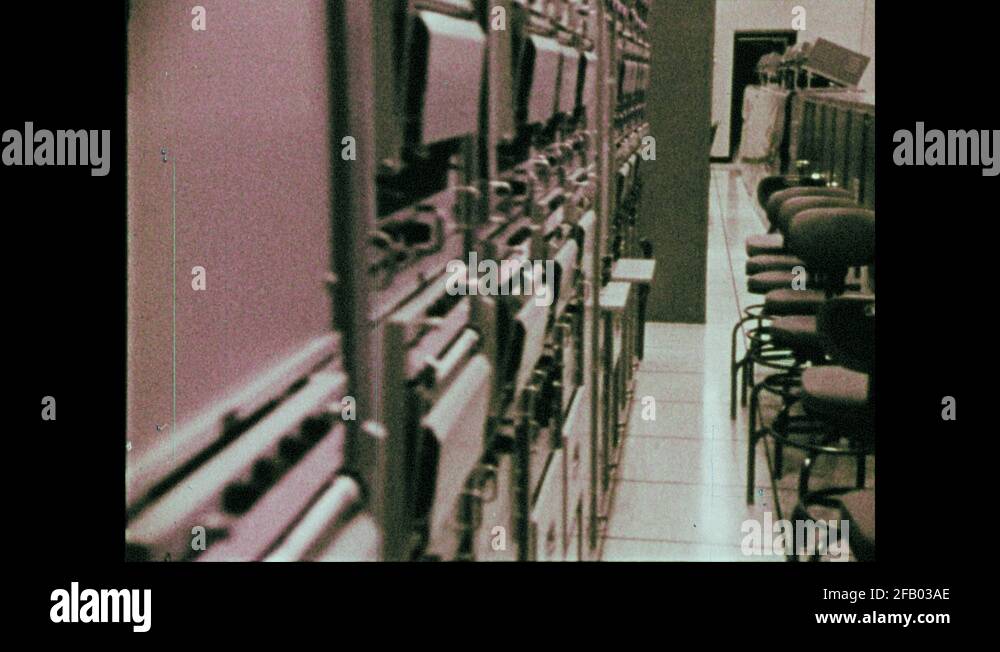 1960s: Rows of computer panels in control room. Steel girders at ...