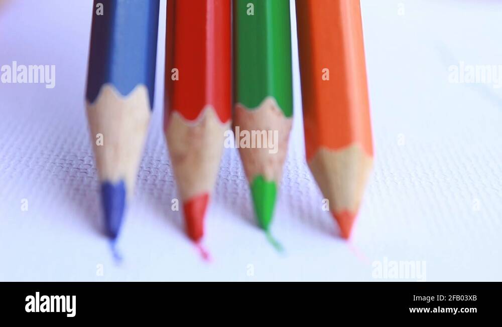 Artists hands drawing 4 colors pencil, blue red green orange write line ...