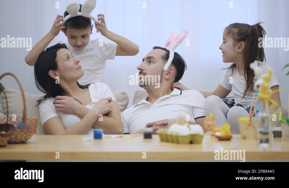 Cute adorable children are standing behind their parents. Little girl ...