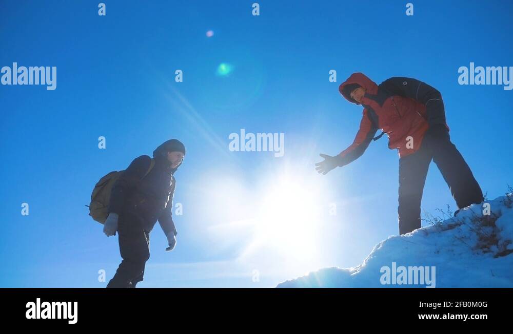 teamwork tourists winter snow business travel trip lends a helping hand ...