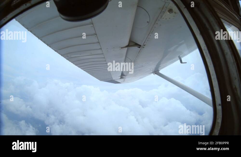 Passanger Looking Out Window in Old Cessna 182 Airplane in Charlevoix ...