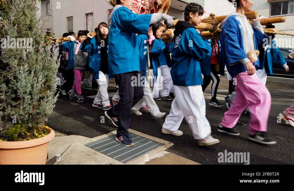 Japanese Children carrying a float (mikoshi) through the streets of ...