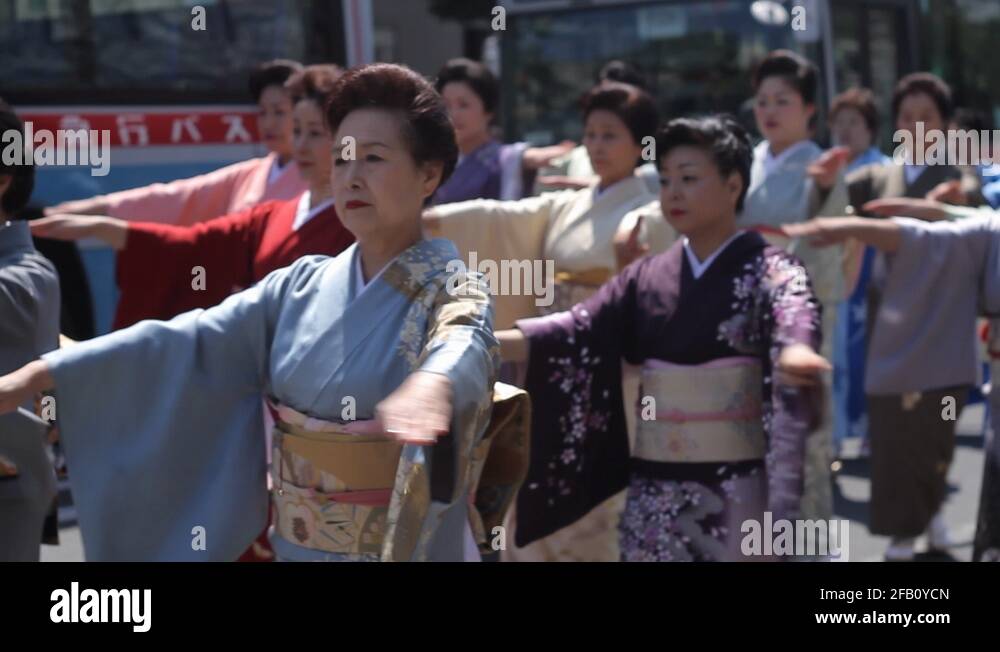 Women in traditional Japanese kimono dance synchronously on the ...