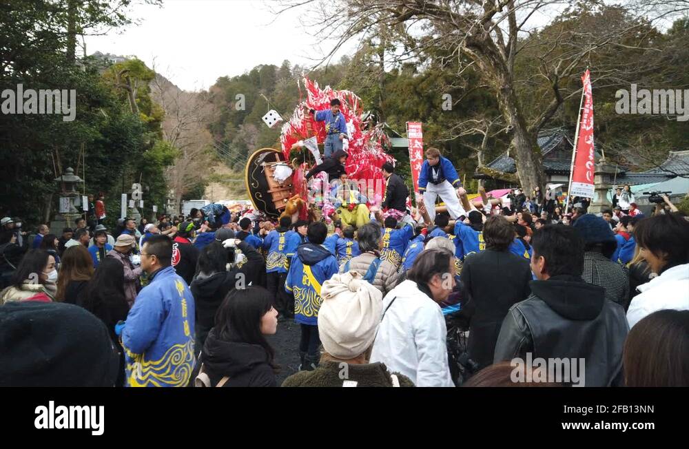 A team of Japanese people picking up a Float (mikoshi) at Hachiman ...