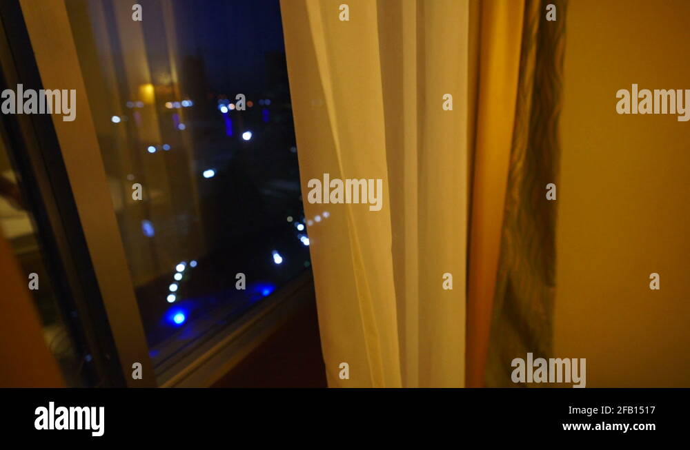 Upper floor hotel room window with night city view Stock Video Footage ...