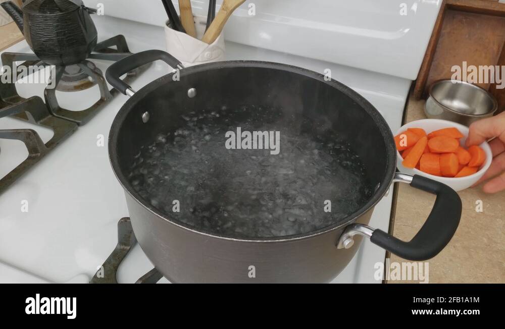 Adding food to boiling water gas stove Stock Videos & Footage - HD and ...