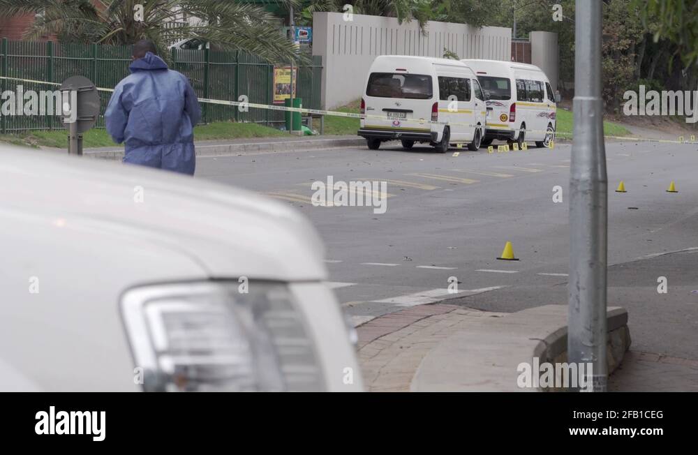 A police forensics investigator maps a drive-by taxi shooting murder ...