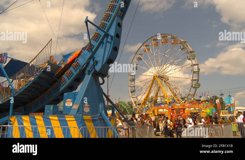 midway rides at fairgrounds - Turbo Loop and Ferris Wheel Stock Video ...