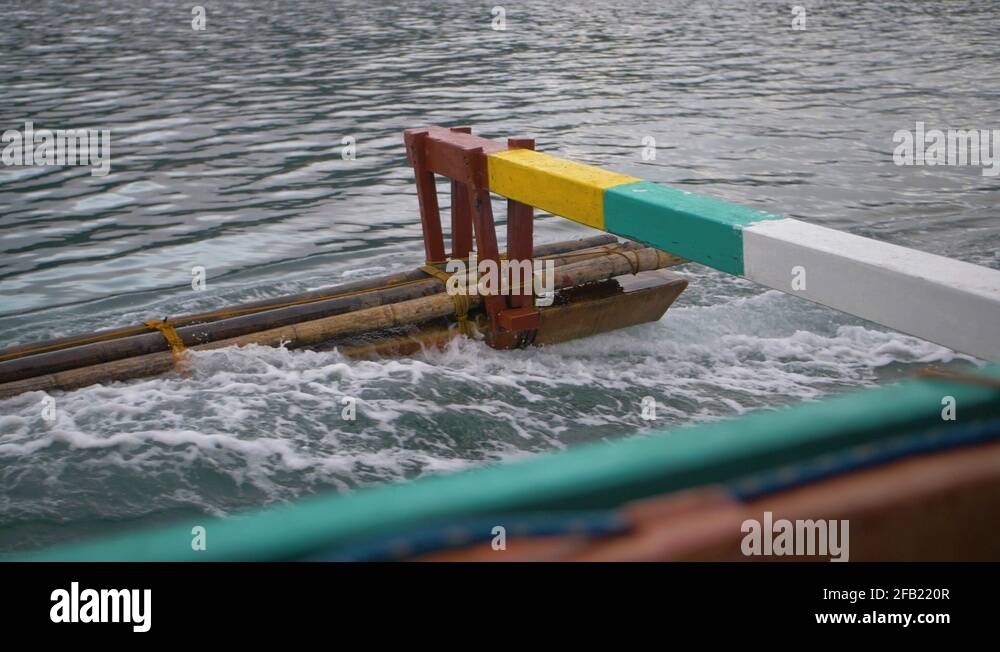 Wooden bamboo outrigger system on a large ferry helps stabilize the ...