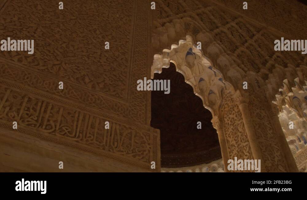 Pan shot inside a beautiful arabic room of the Alhambra with columns ...