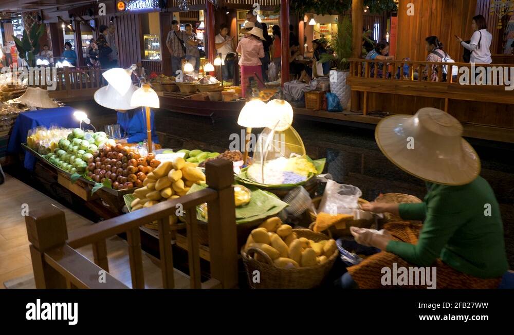 Traditional floating market boat sellers trading indoors inside luxury ...