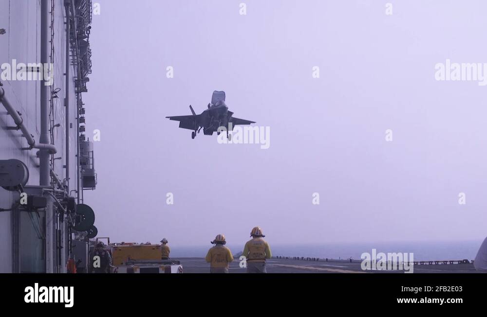 Plane director watch F-35B Lightning II hover above flight deck of USS ...