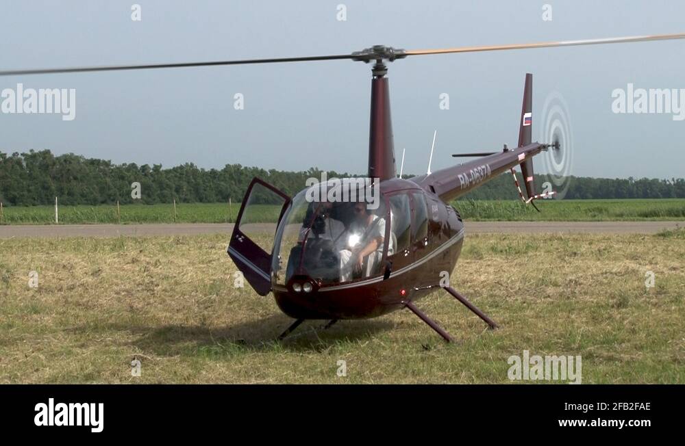 Robinson R44 helicopter with open cabin door with rotating two-blade ...