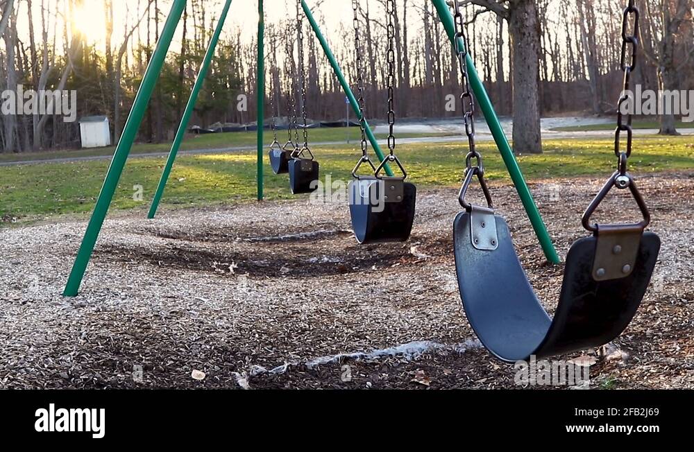 Swings at park swinging in the wind Stock Video Footage - Alamy