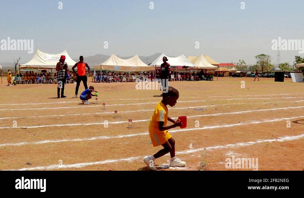 Primary school children match pass with their king and queen bringing ...