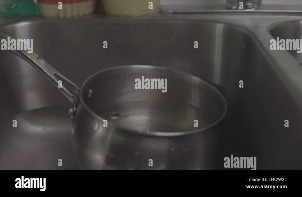 Water drips into a pot that's sittin in the sink. 4k 30p footage Stock ...