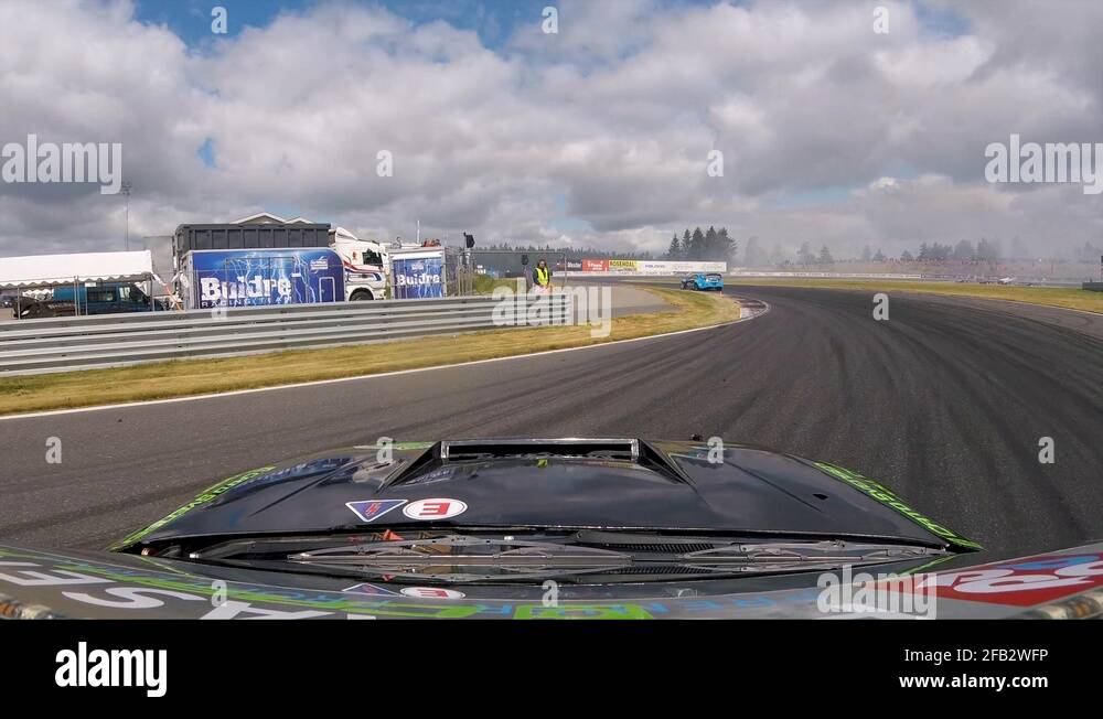 Racing car breaking its motor on a dangerous curve during a race Stock ...