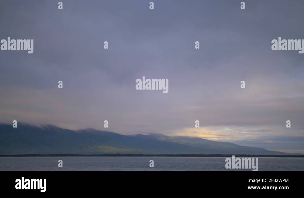 Purple haze on a cloudy sky over an island in the Philippines. Heavy ...