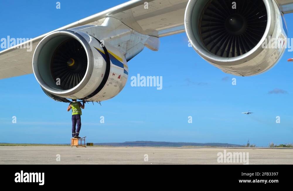 Ground personnel checks the engine of Antonov An-124 Ruslan aircraft ...