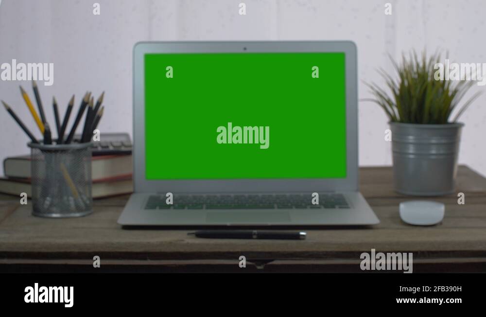 4K : A laptop computer with a key green screen set on work office table ...